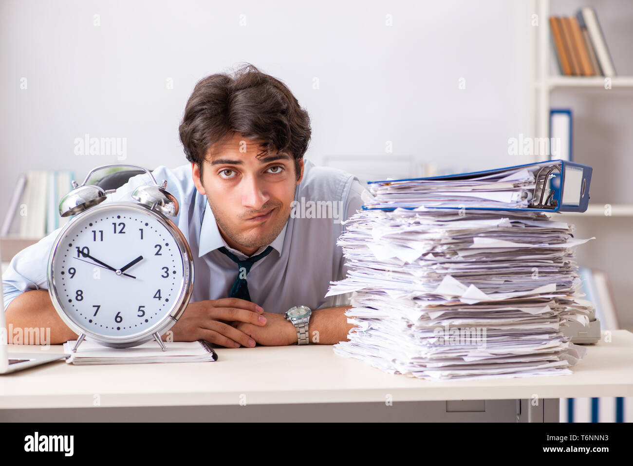 The overloaded busy employee with too much work and paperwork Stock ...