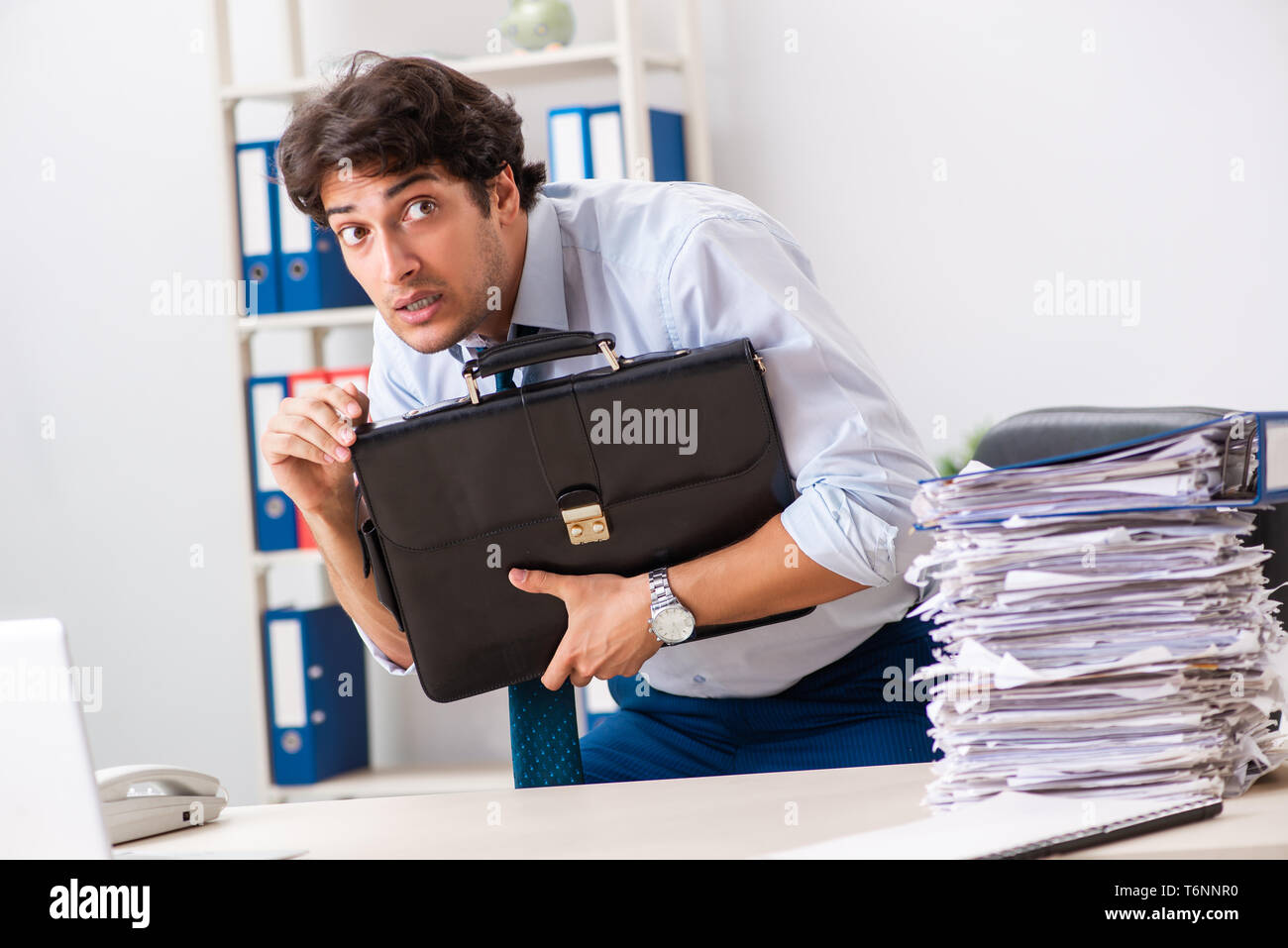 The overloaded busy employee with too much work and paperwork Stock ...