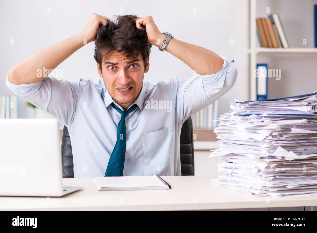 The overloaded busy employee with too much work and paperwork Stock ...