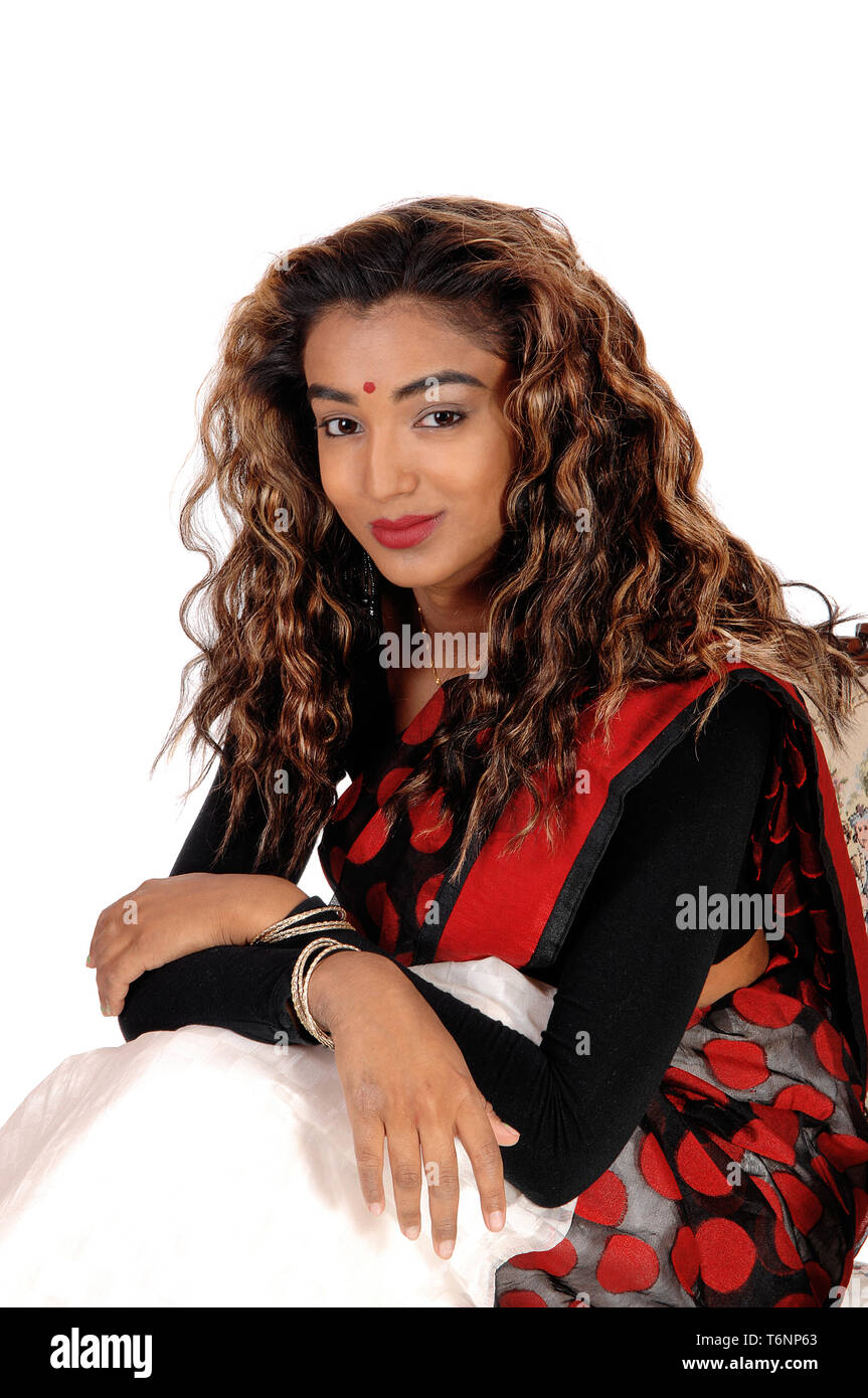 Smiling beautiful East Indian woman sitting in a dress Stock Photo - Alamy