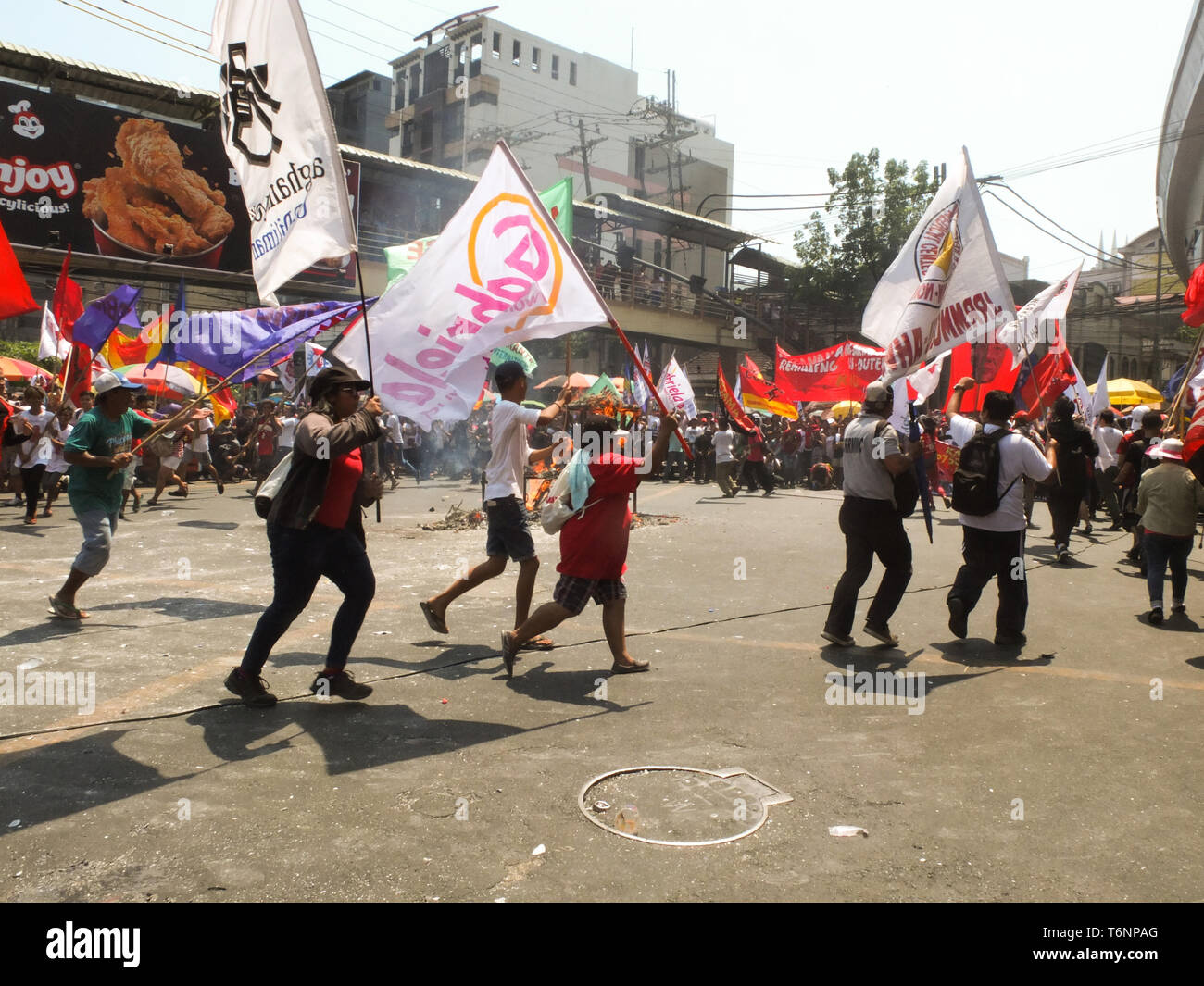 Workers are seen holding flags during the Labour Day Protest in Manila ...