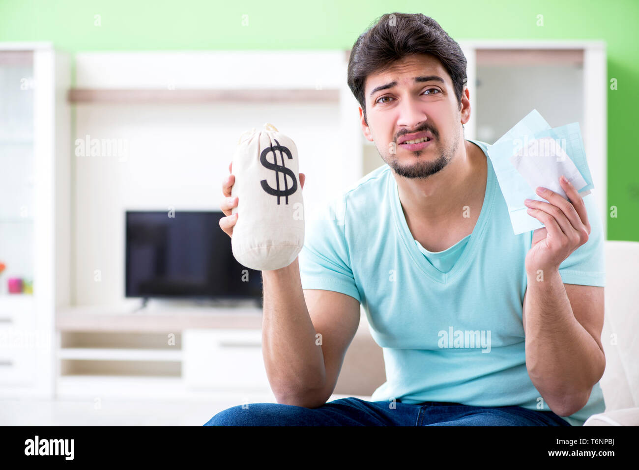 The young man struggling with personal finance and bills Stock Photo ...