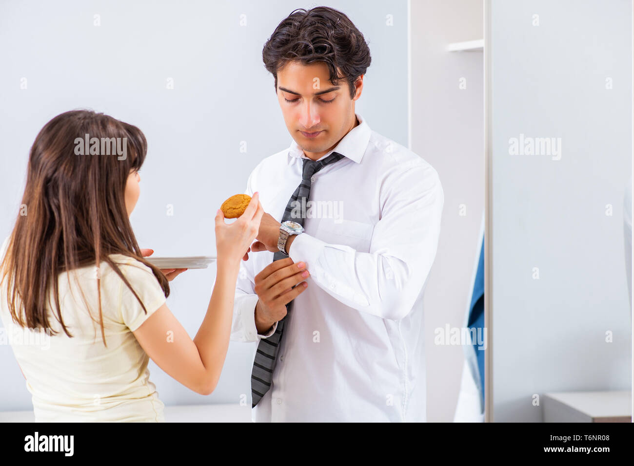 Woman sees her husband off to work Stock Photo - Alamy