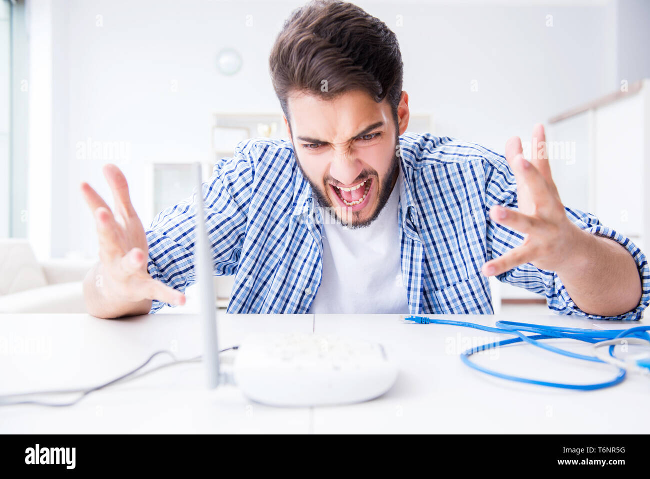 Frustrated young man due to weak internet reception Stock Photo - Alamy