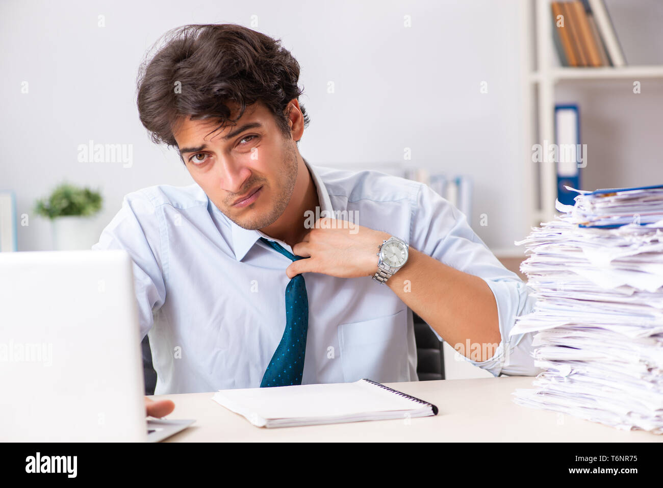 Overloaded busy employee with too much work and paperwork Stock Photo ...