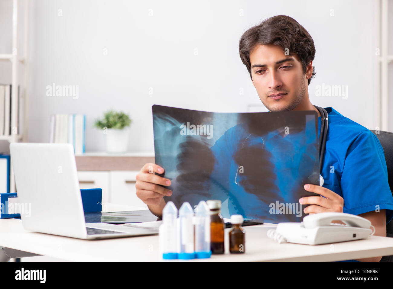 Male doctor radiologist with x-ray can image Stock Photo - Alamy