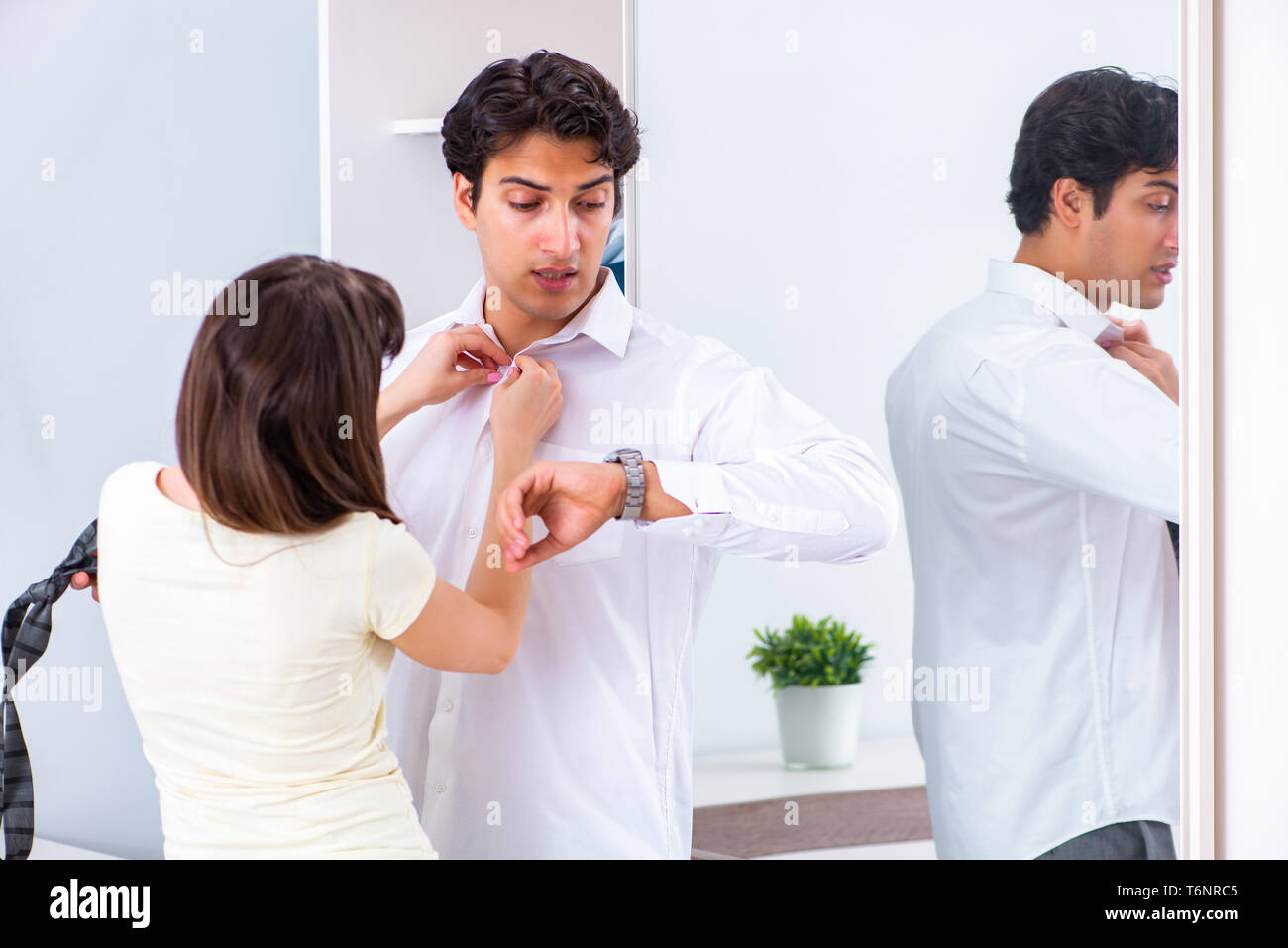 Woman sees her husband off to work Stock Photo - Alamy