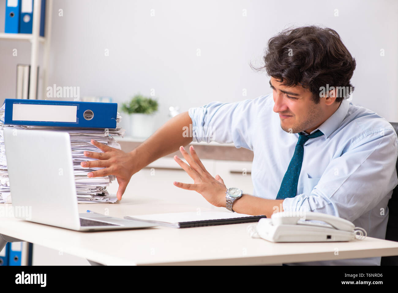 Overloaded busy employee with too much work and paperwork Stock Photo ...