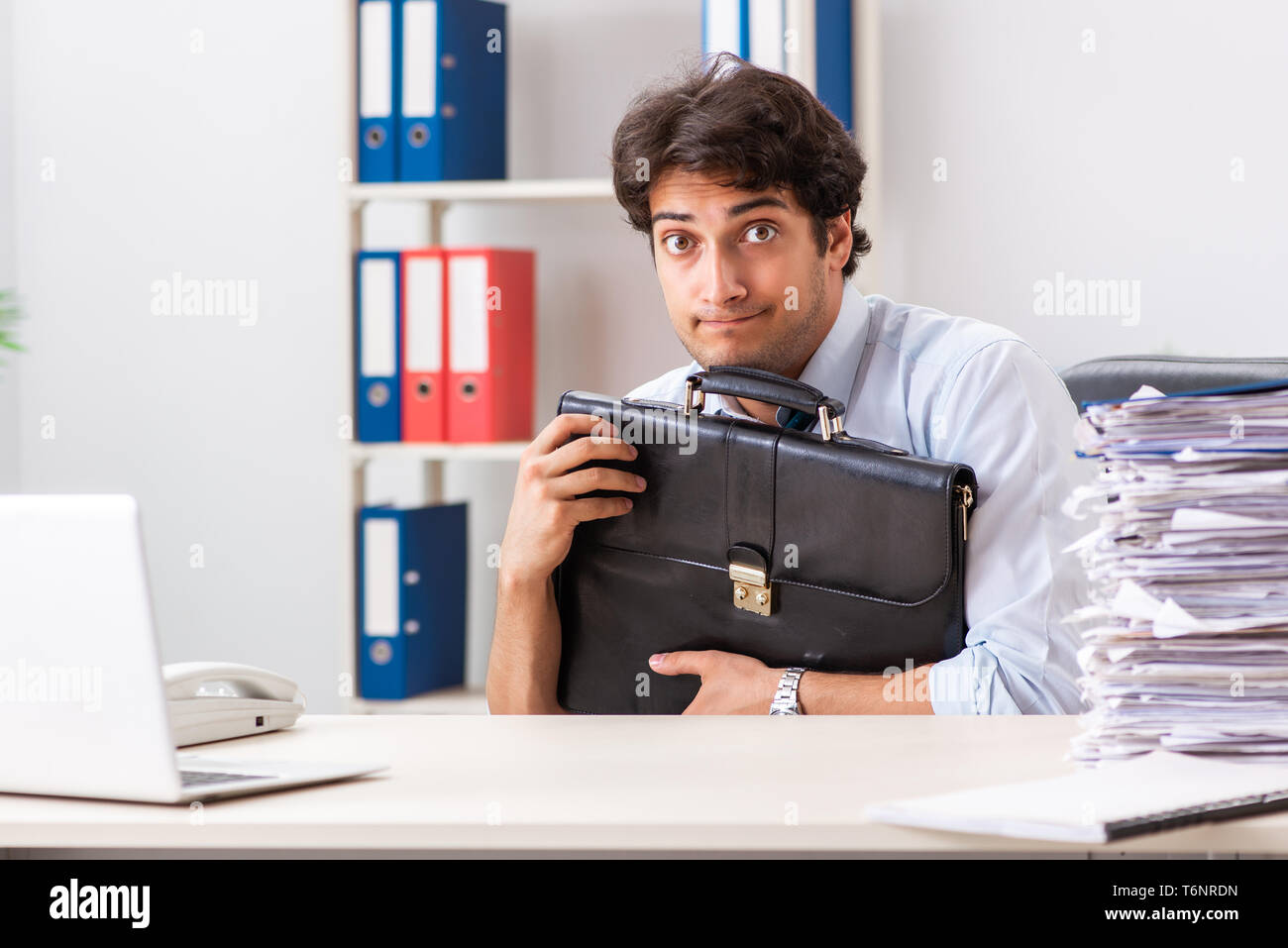 Overloaded busy employee with too much work and paperwork Stock Photo ...