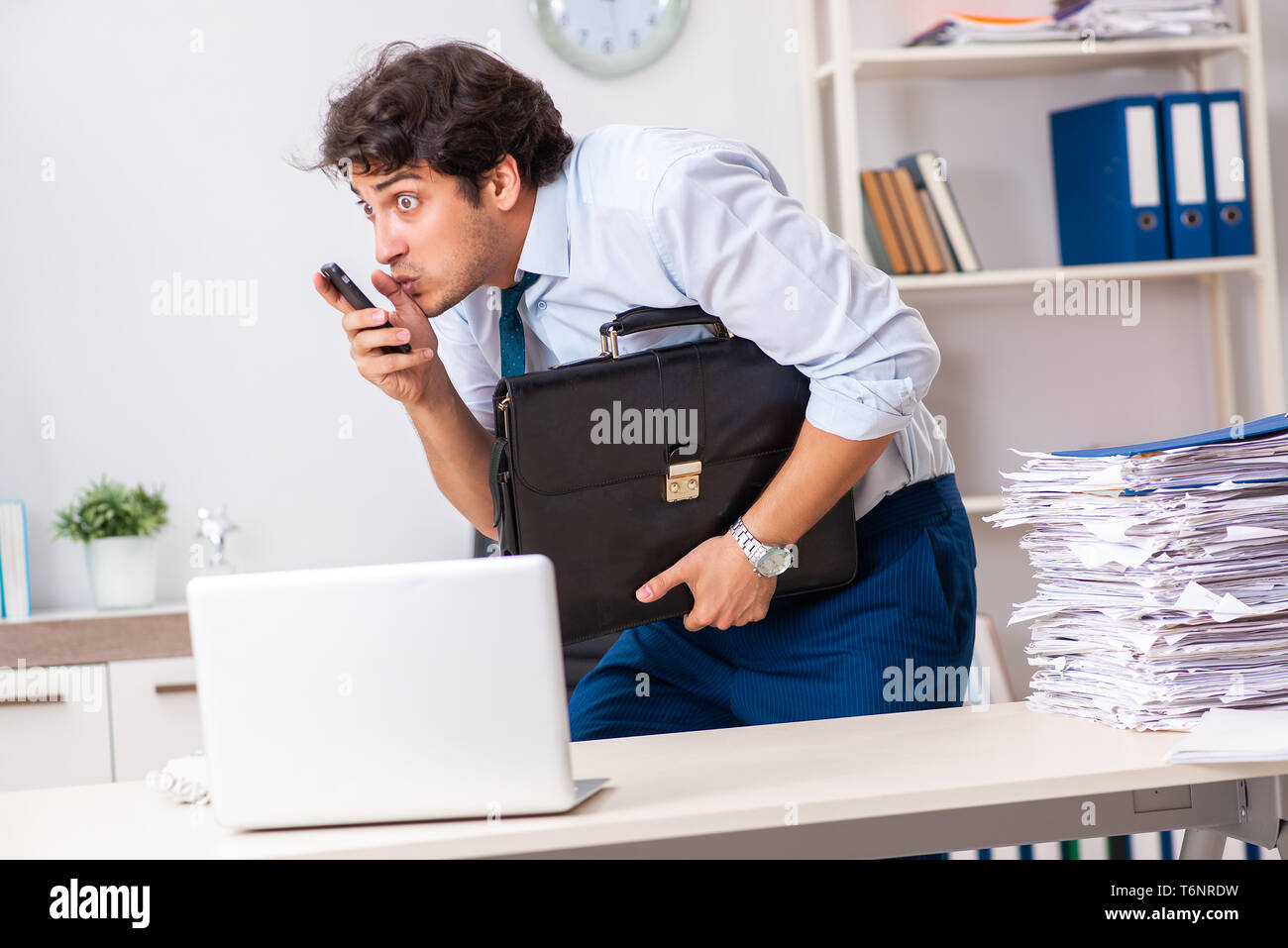 Overloaded busy employee with too much work and paperwork Stock Photo ...