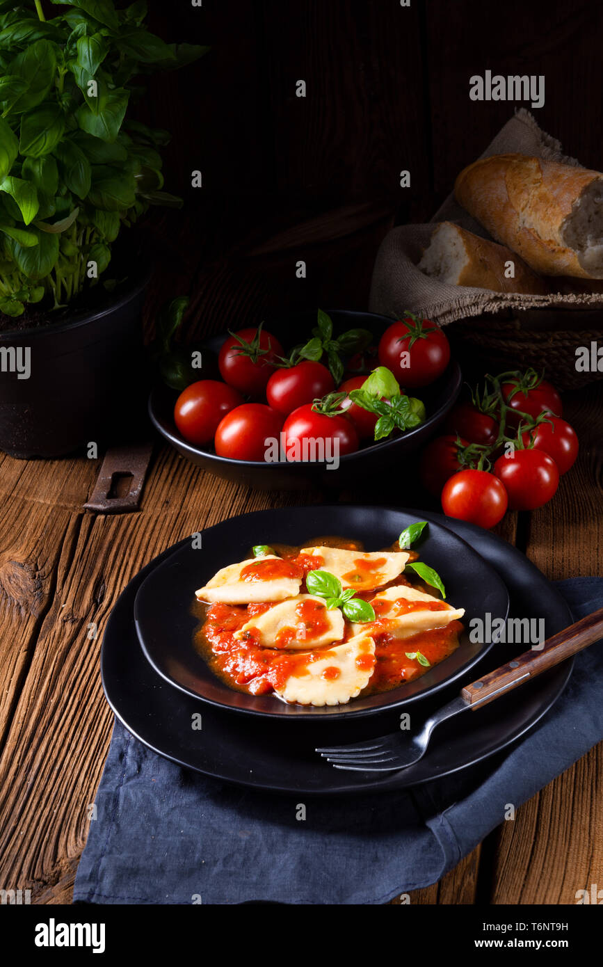 rustic Delicious Pasta - Ravioli in tomato sauce with basil Stock Photo ...