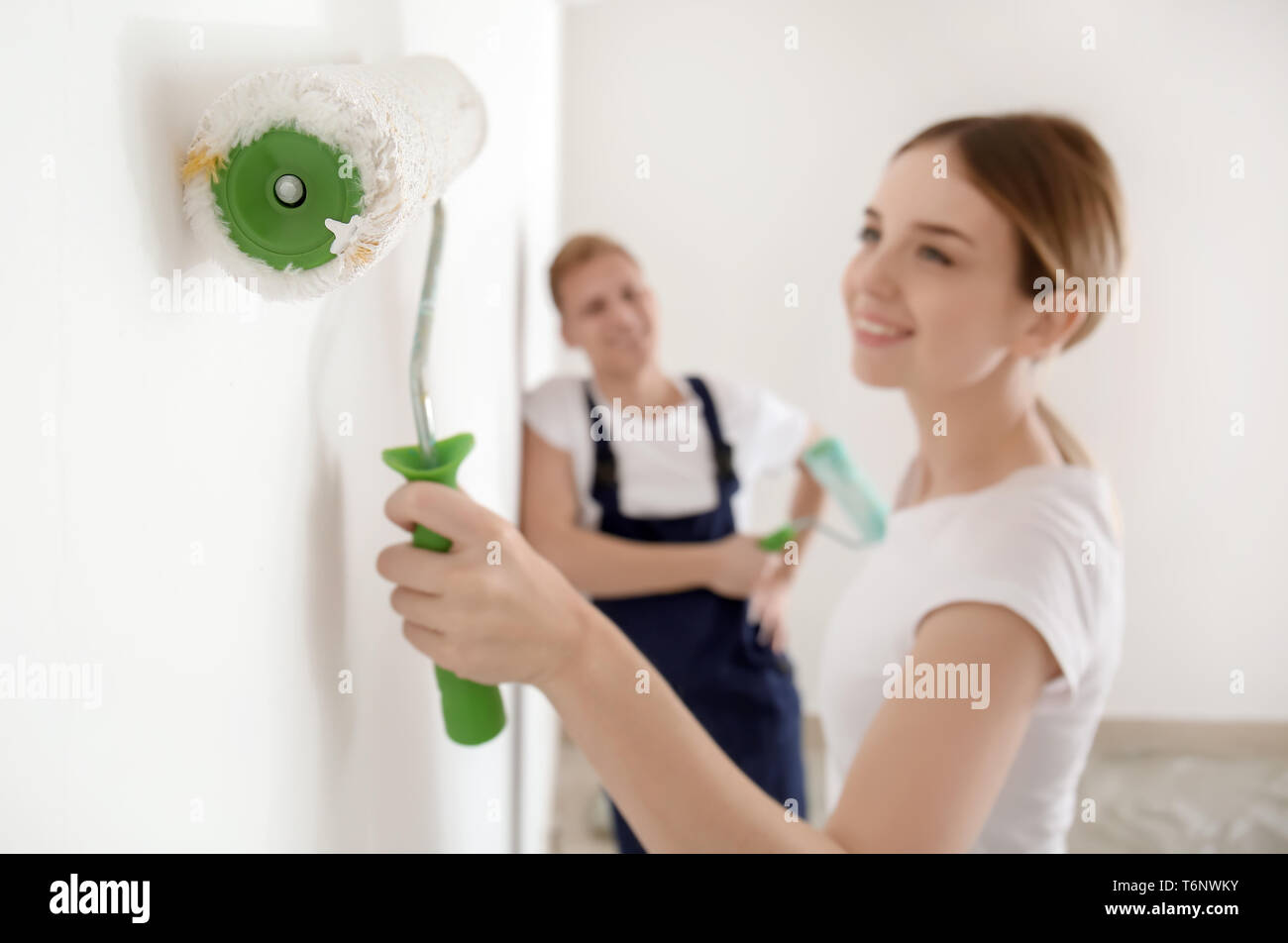 Young painter working under foreman supervision in room Stock Photo - Alamy