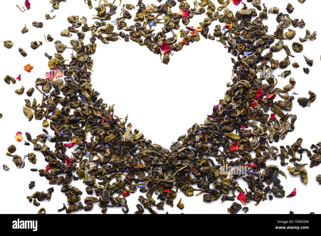 Heart made of dry green tea on white background Stock Photo - Alamy