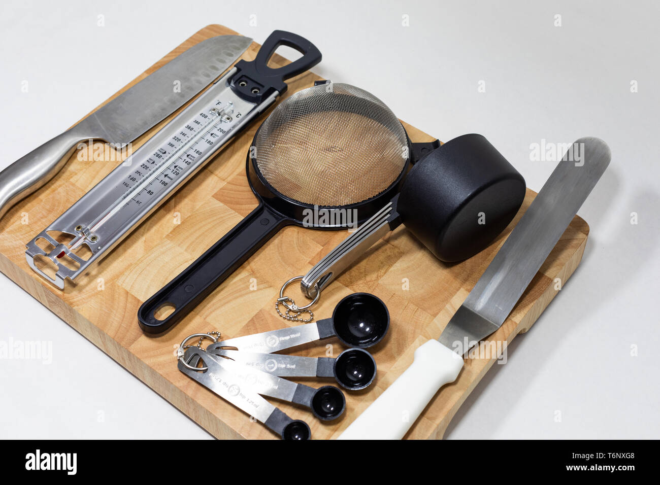 Flat lay of cooking/baking essential utensils with wooden chopping ...
