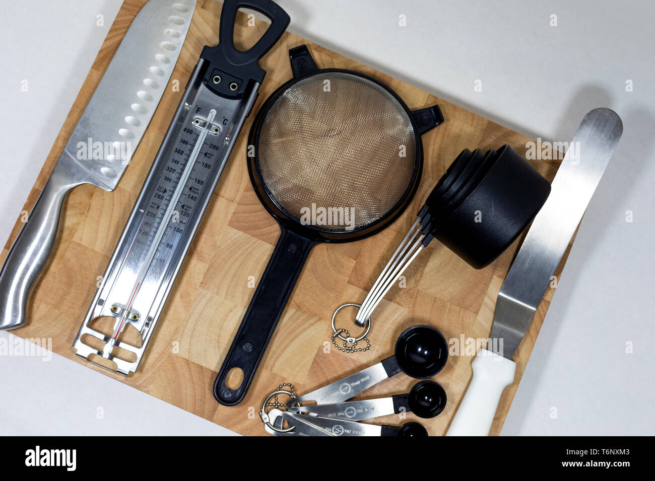 Flat lay of cooking/baking essential utensils with wooden chopping ...