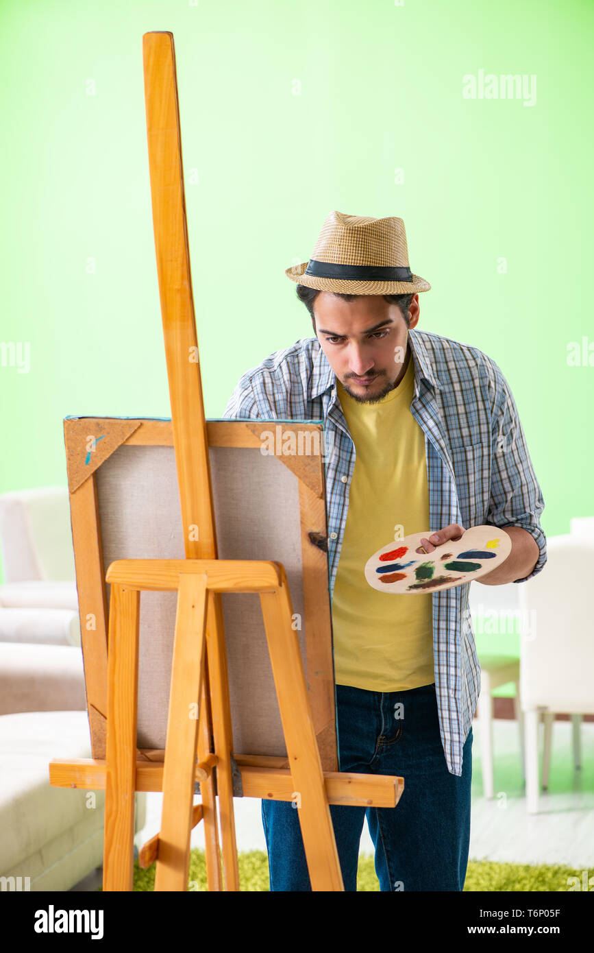 Young male artist working on new painting in his studio Stock Photo - Alamy