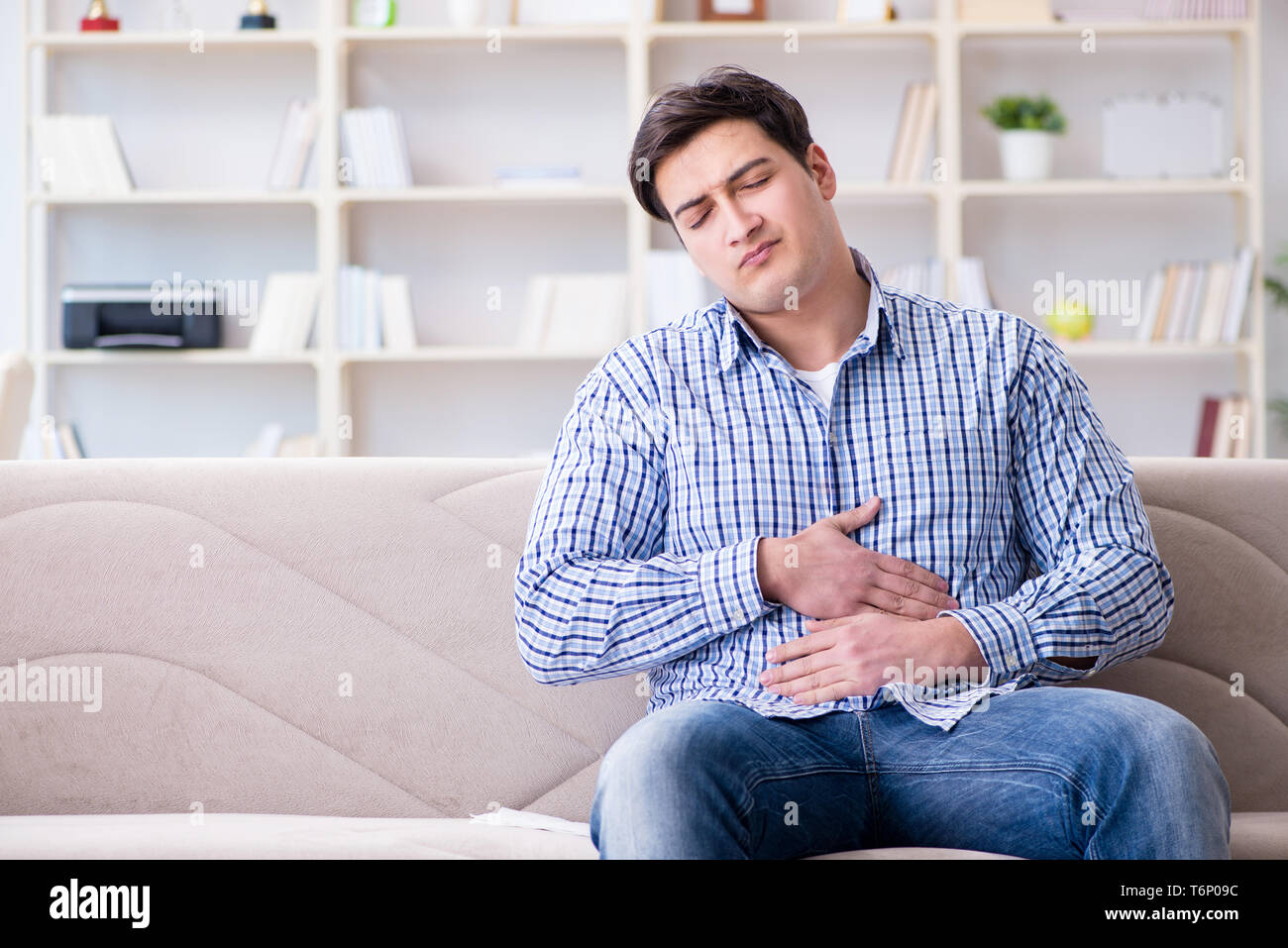 Sick man suffering at home from infection and bad stomach Stock Photo ...