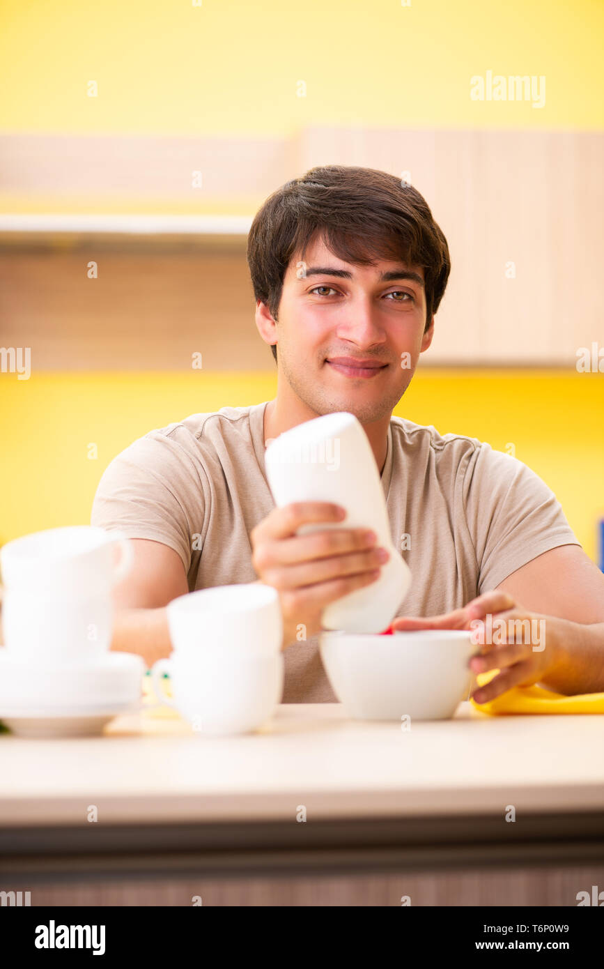 Man washing dishes at home Stock Photo - Alamy