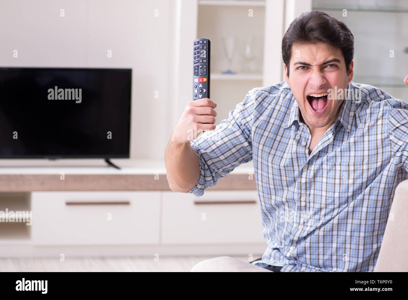 Man yelling at tv hi-res stock photography and images - Alamy