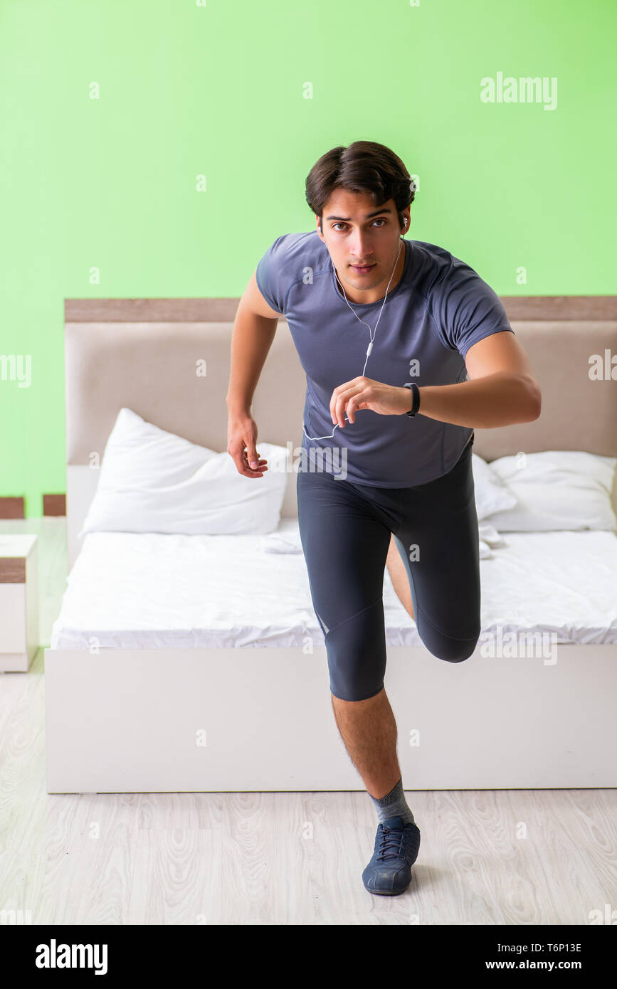 Young handsome man doing morning exercises in the hotel room Stock ...