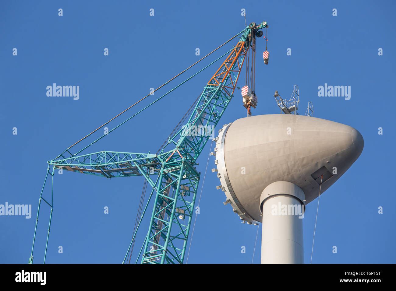 Construction site wind turbine with hoisting of rotor house Stock Photo ...