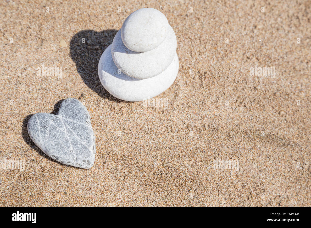Sandy beach with pebble heart hi-res stock photography and images - Alamy