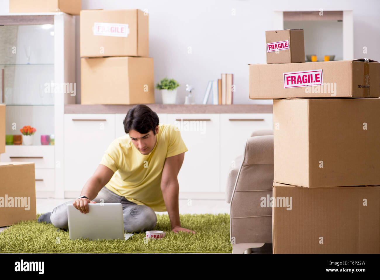 Man moving house and relocating with fragile items Stock Photo - Alamy