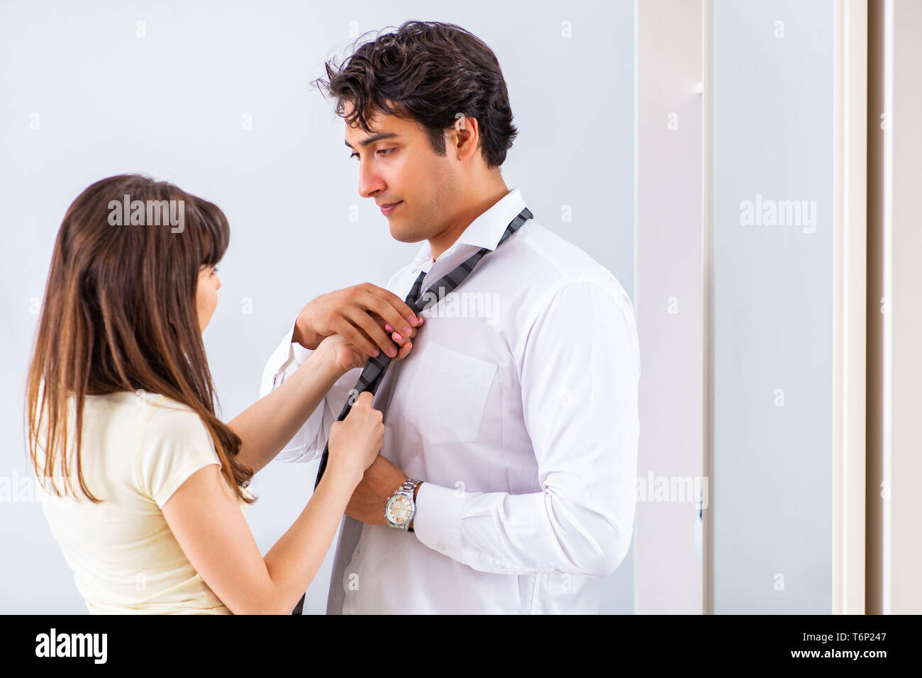 Woman sees her husband off to work Stock Photo - Alamy