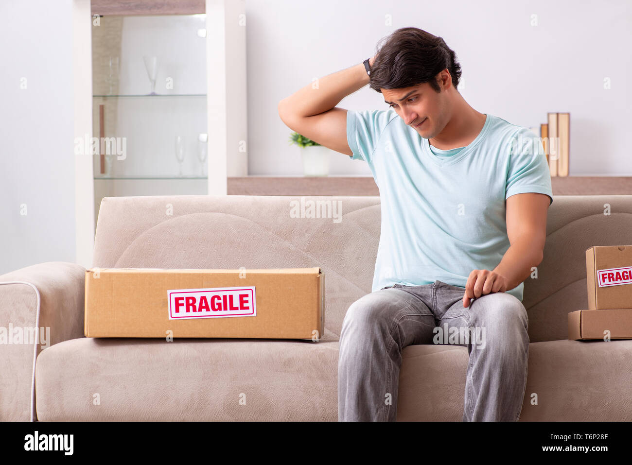 Man opening fragile parcel ordered from internet Stock Photo - Alamy