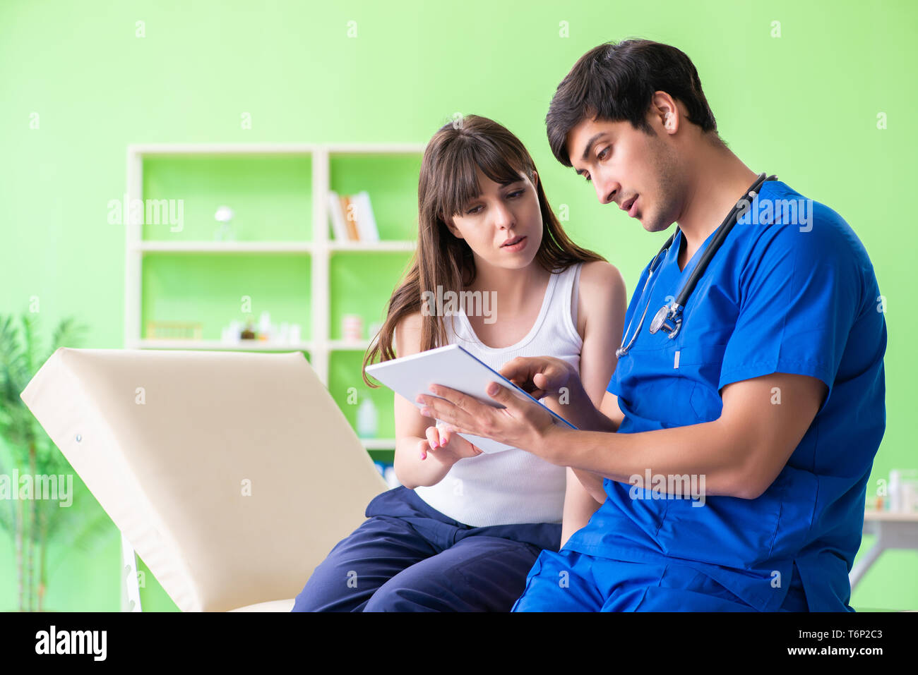 Female patient visiting male doctor in medical concept Stock Photo - Alamy