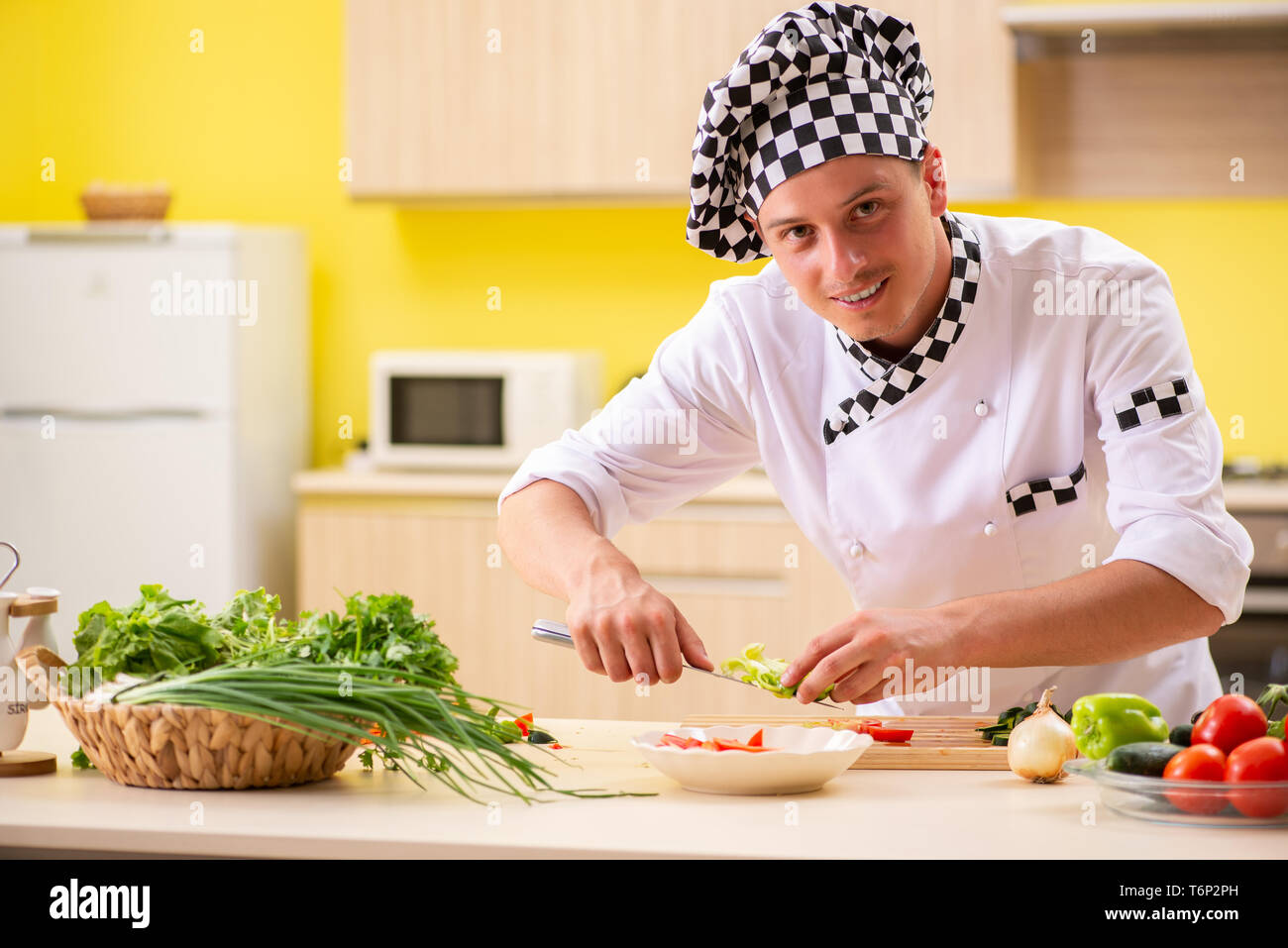 Young professional cook preparing salad at kitchen Stock Photo - Alamy