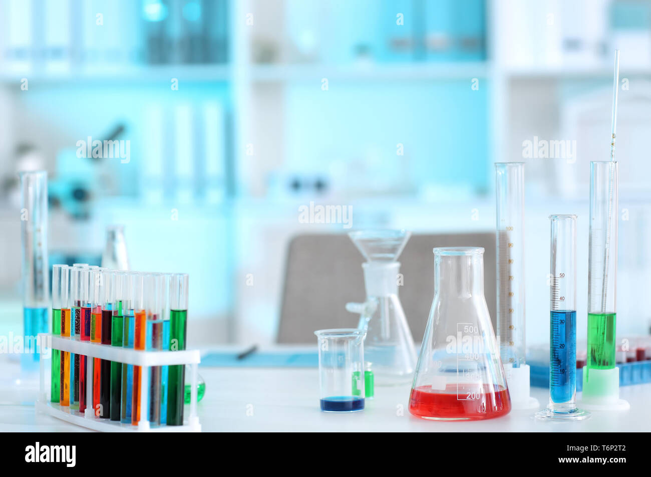 Glassware with different samples on table in laboratory Stock Photo - Alamy