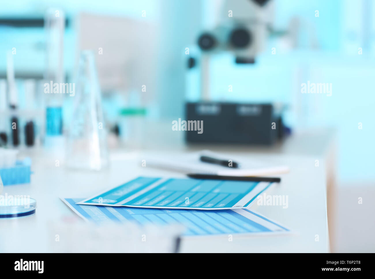 Sheets of paper with test results on table in laboratory Stock Photo ...