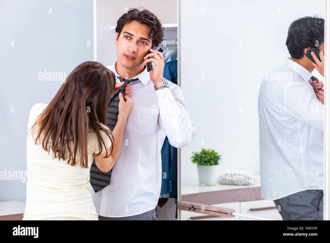 Woman sees her husband off to work Stock Photo - Alamy