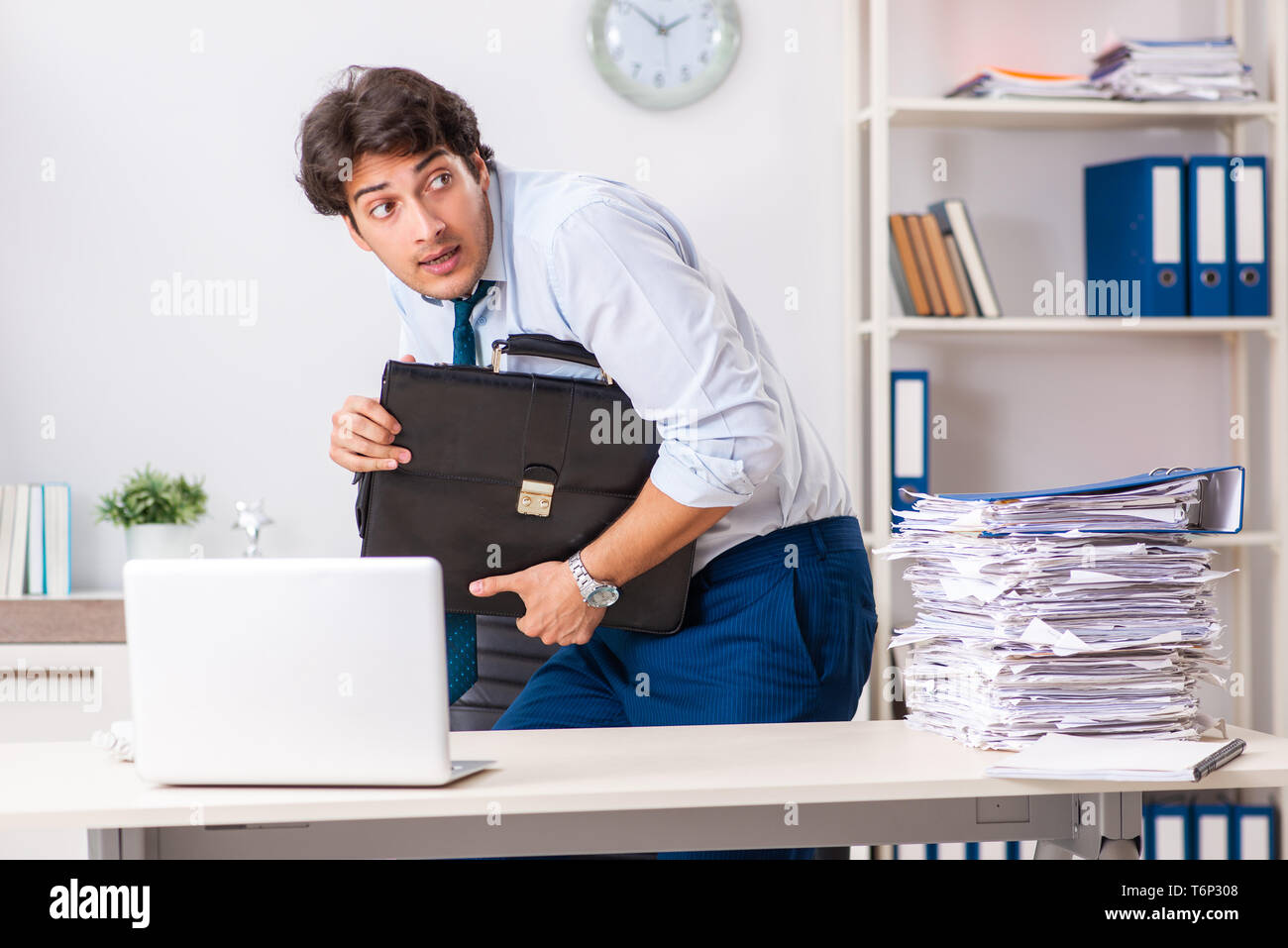 Overloaded busy employee with too much work and paperwork Stock Photo ...
