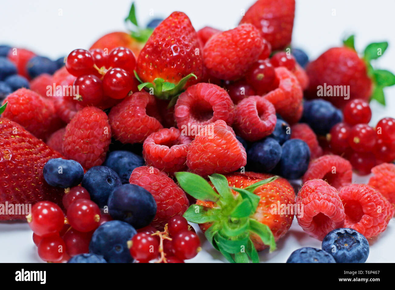 assorted fresh berries with white background Stock Photo - Alamy