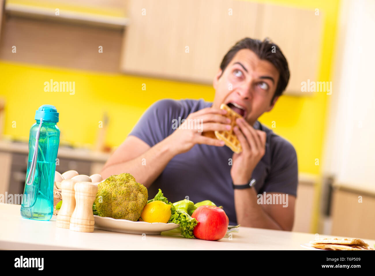 Man having hard choice between healthy and unhealthy food Stock Photo ...