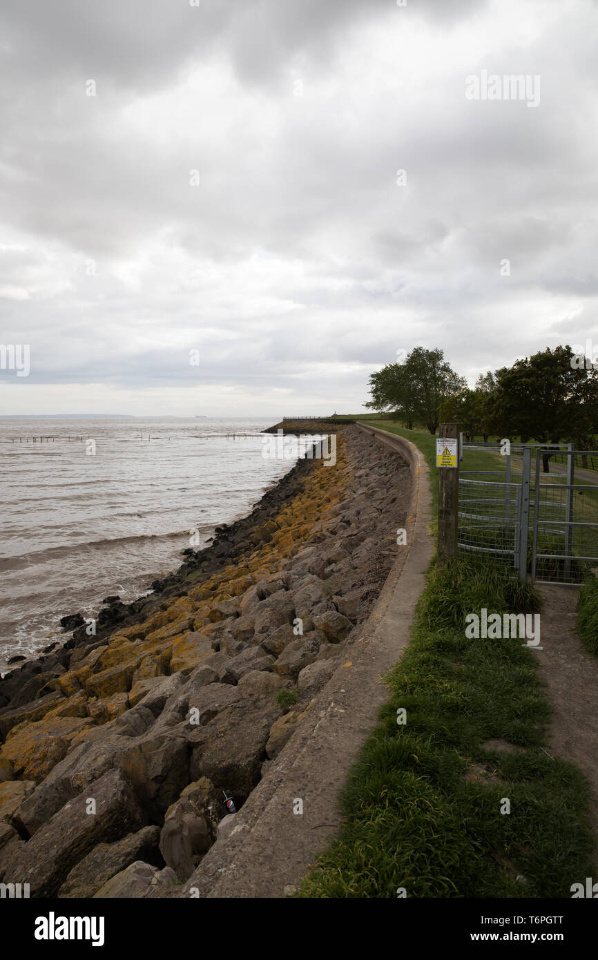 Goldcliff, Newport, UK. 2nd May, 2019. People walk along the sea wall ...