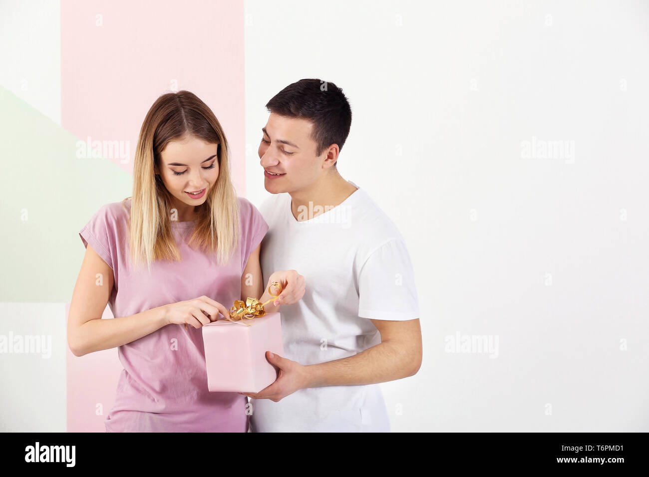 Young husband opening birthday gift hi-res stock photography and images ...
