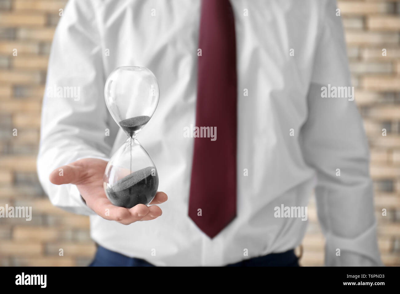 Man holding hourglass on blurred background, closeup. Time management ...