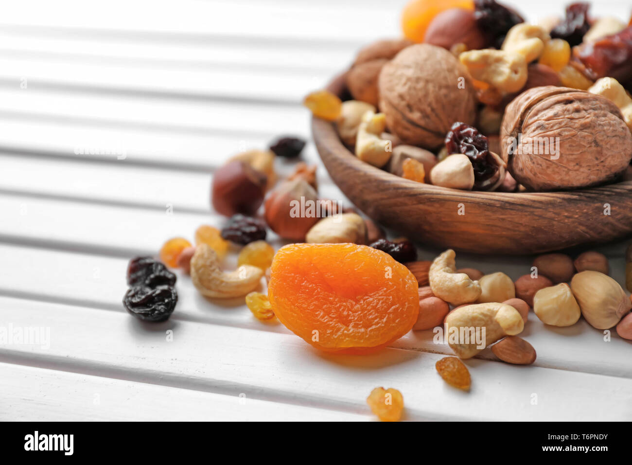 Plate with different nuts and dried fruits on wooden table Stock Photo ...