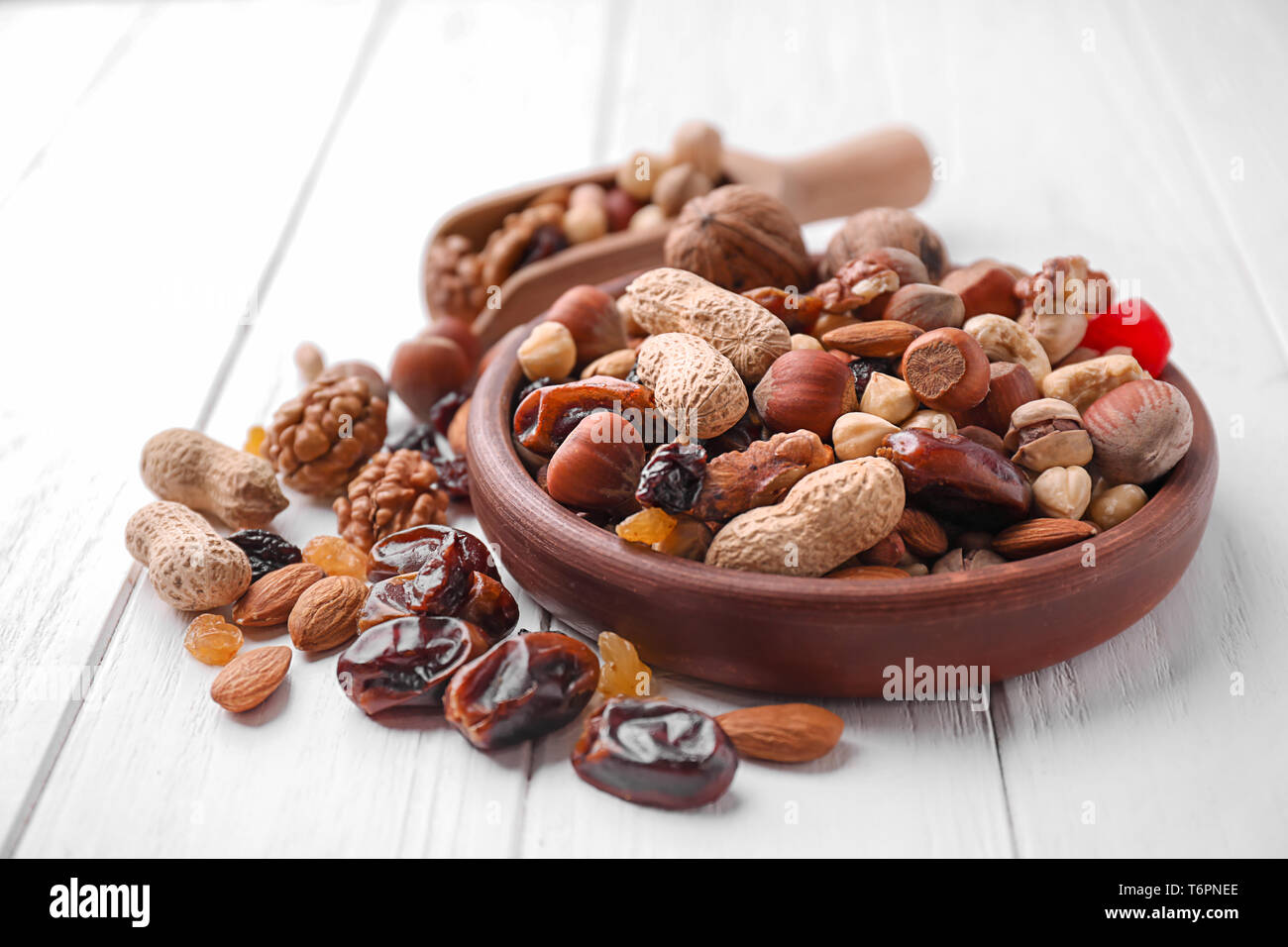 Plate with different nuts and dried fruits on wooden table Stock Photo ...