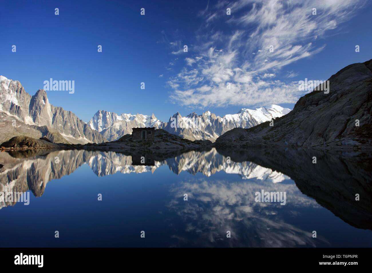 The Aiguilles de Chamonix mountains reflected in Lac Blanc lake, far ...
