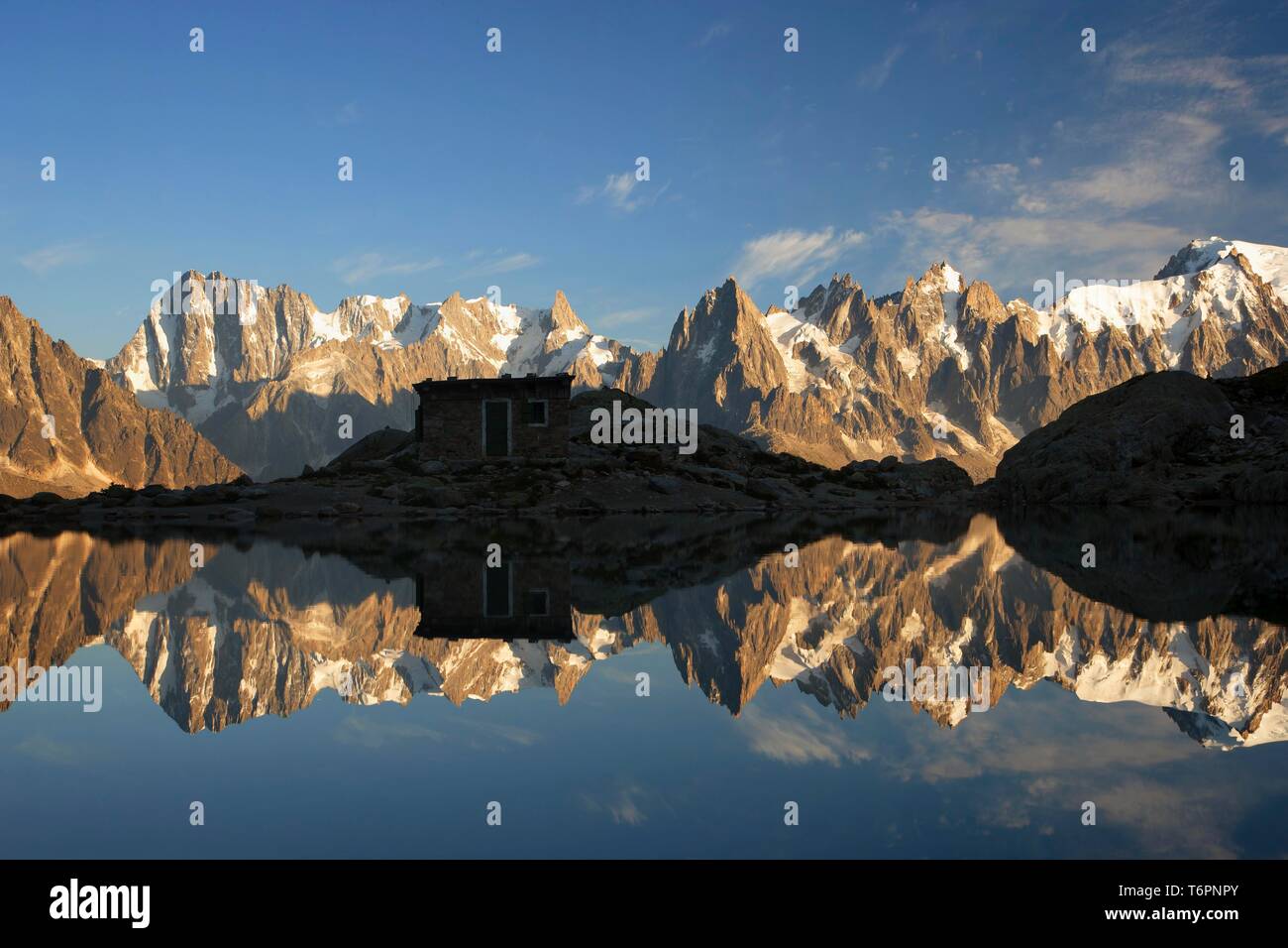 The Aiguilles de Chamonix mountains reflected in Lac Blanc lake, far ...