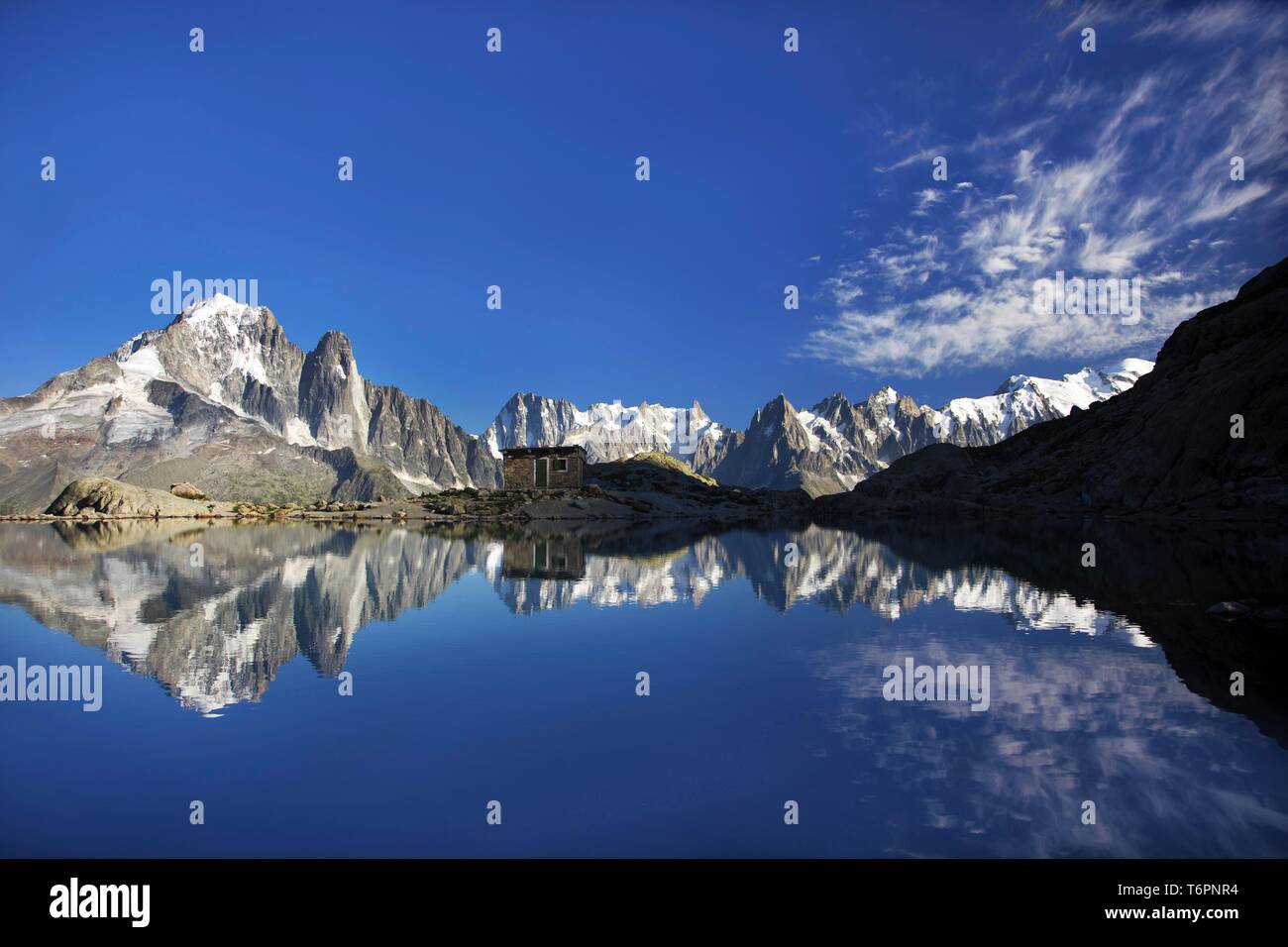 The Aiguilles de Chamonix mountains reflected in Lac Blanc lake, far ...