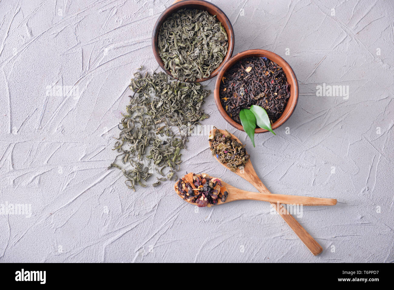 Flat lay composition with different types of dry tea leaves on light ...