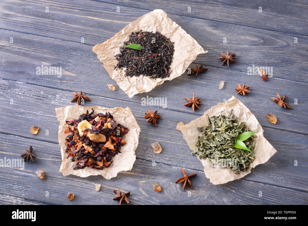 Different types of dry tea leaves on wooden background Stock Photo - Alamy