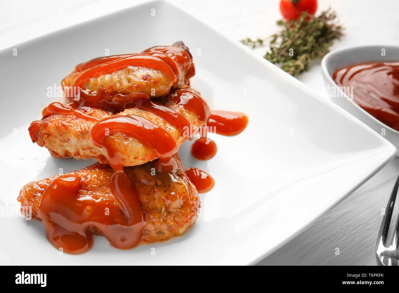 Roasted chicken with barbecue sauce on plate, closeup Stock Photo - Alamy
