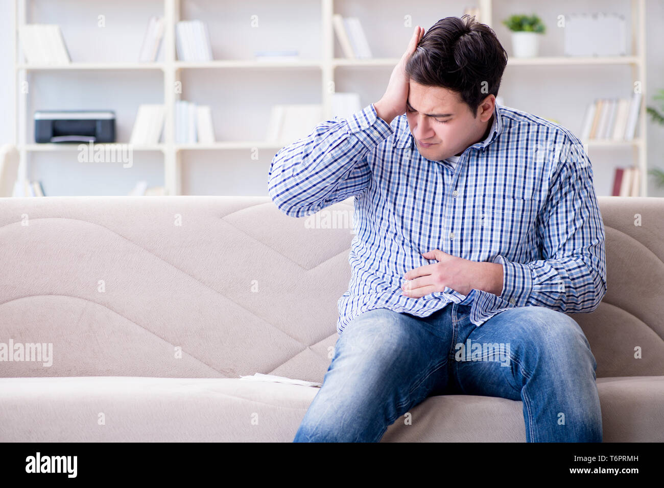Sick man suffering at home from infection and bad stomach Stock Photo ...