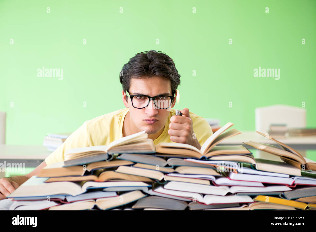 Student with too many books to read before exam Stock Photo - Alamy